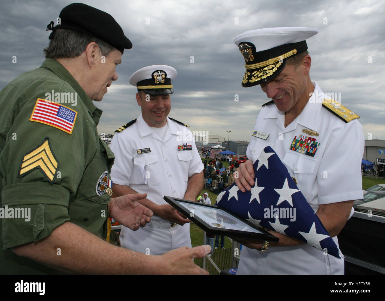 Bob Engstrom, left, presents a flag to Vice Adm. Dirk Debbink, Chief of ...
