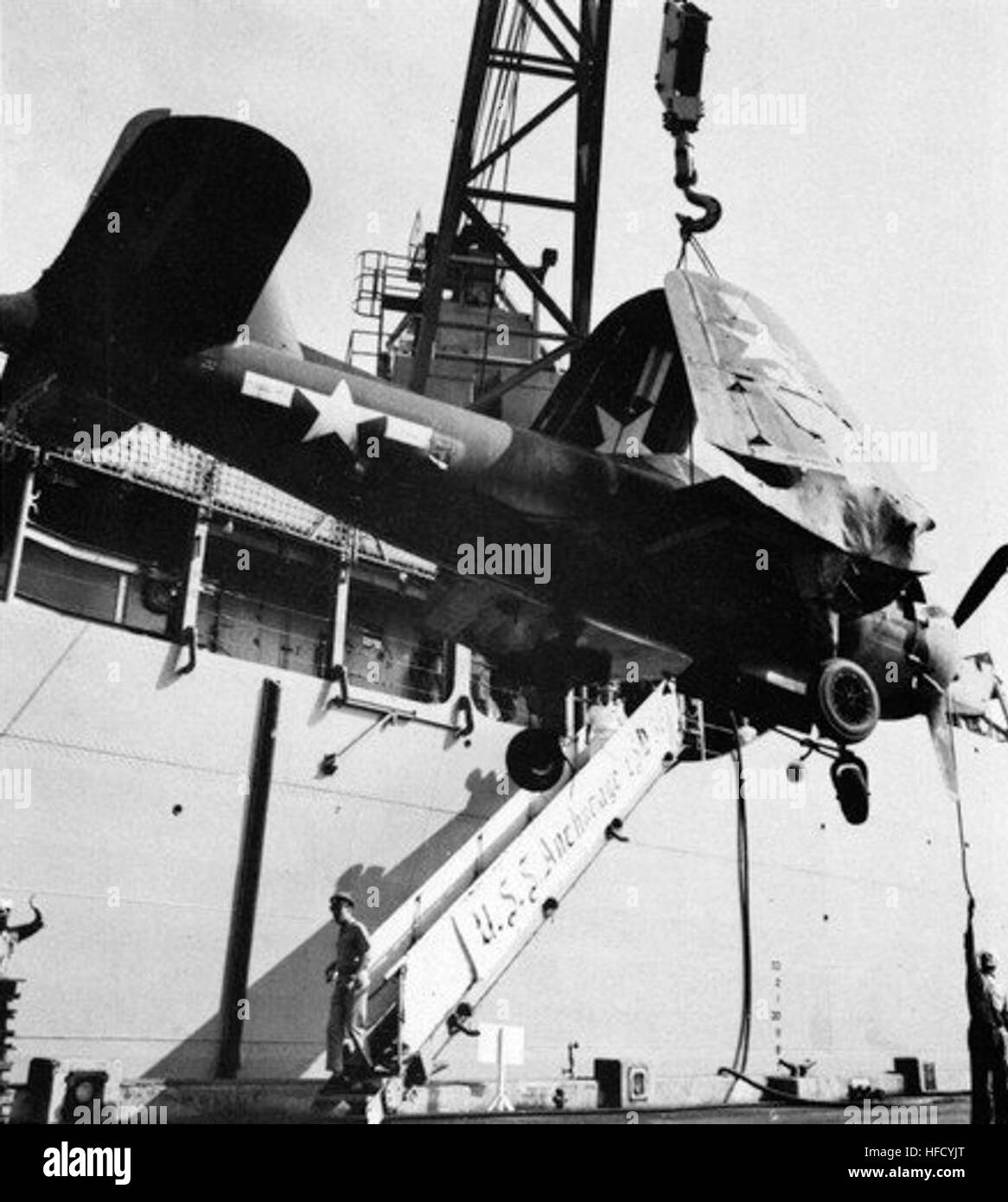 A Ryan FR Fireball aircraft is hoisted aboard USS Anchorage (LSD-36) to ...