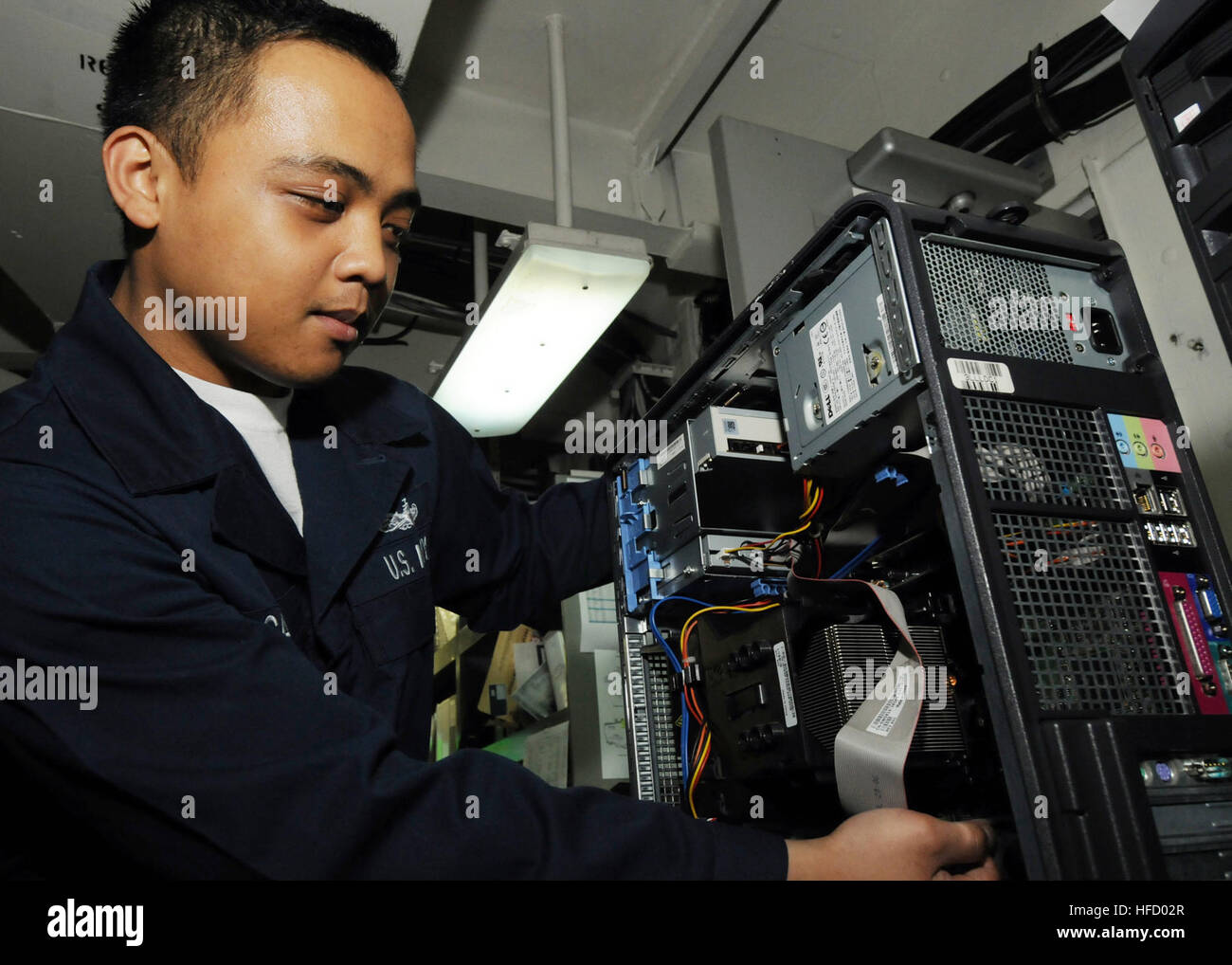 Seaman Michael Cadiz checks the RAM on a computer in the automatic data ...