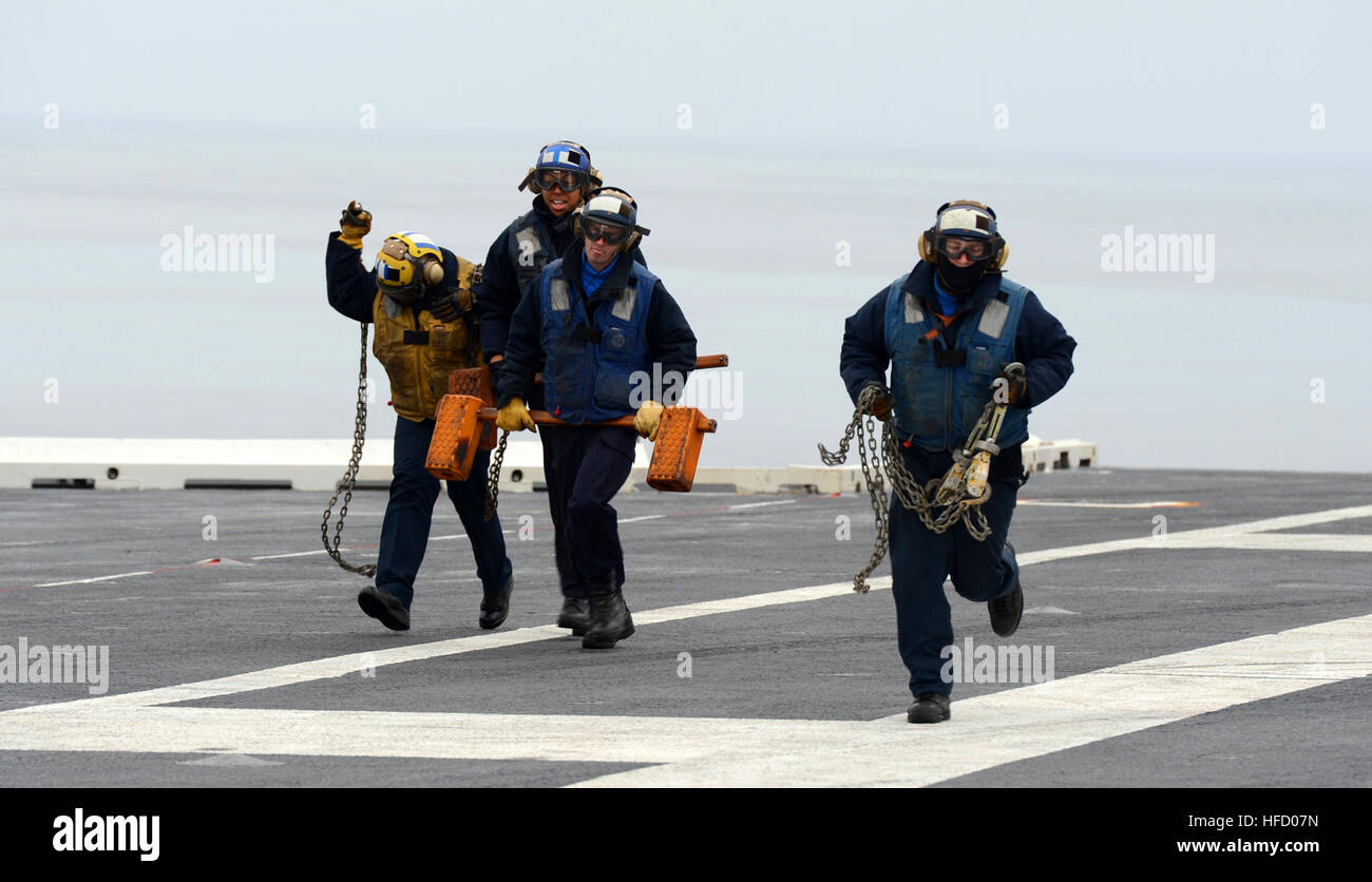 ATLANTIC OCEAN (Jan. 28, 2013) Sailors carry chocks and chains across ...