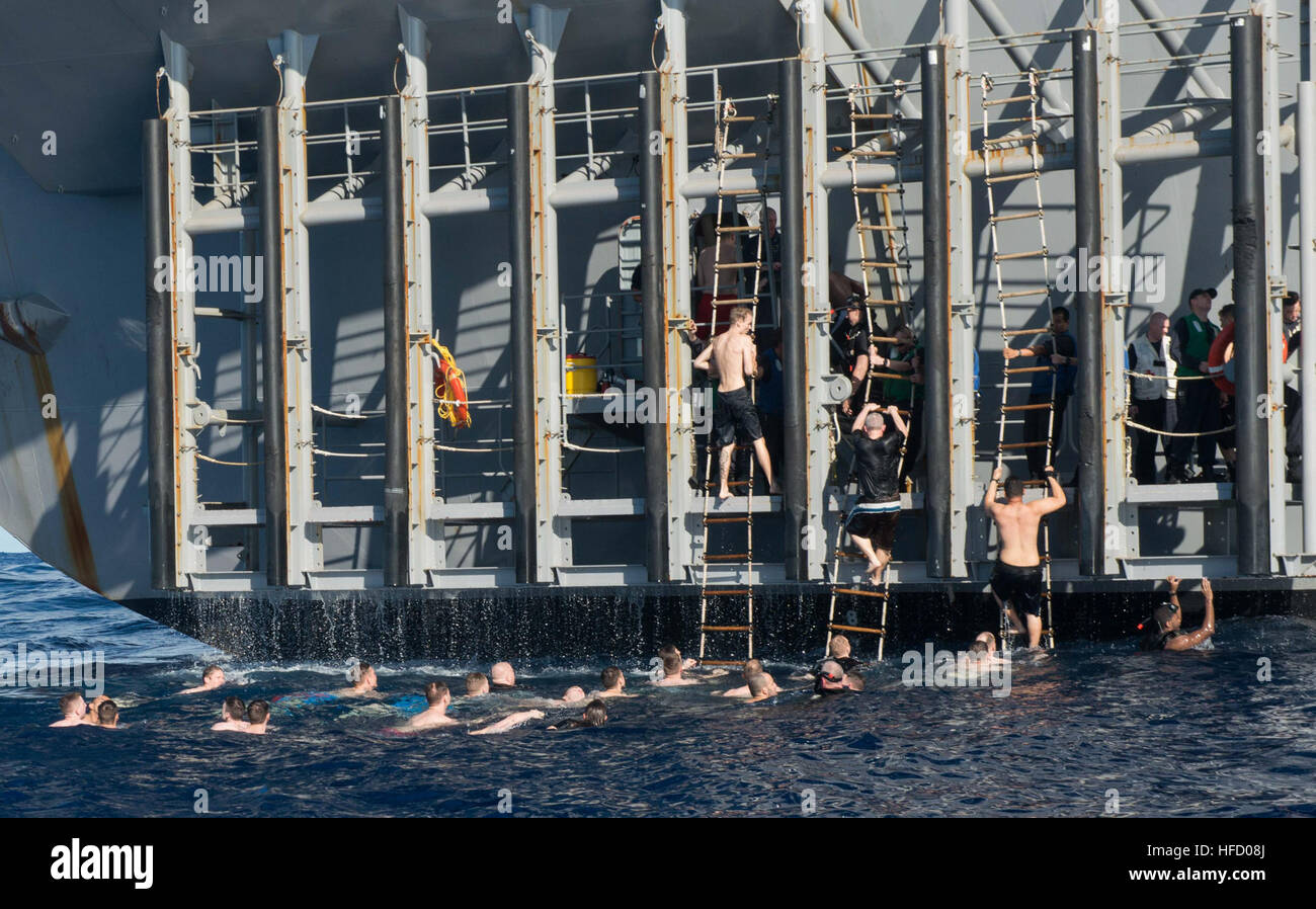 Sailors return aboard USS John C. Stennis (CVN 74) after a swim call ...