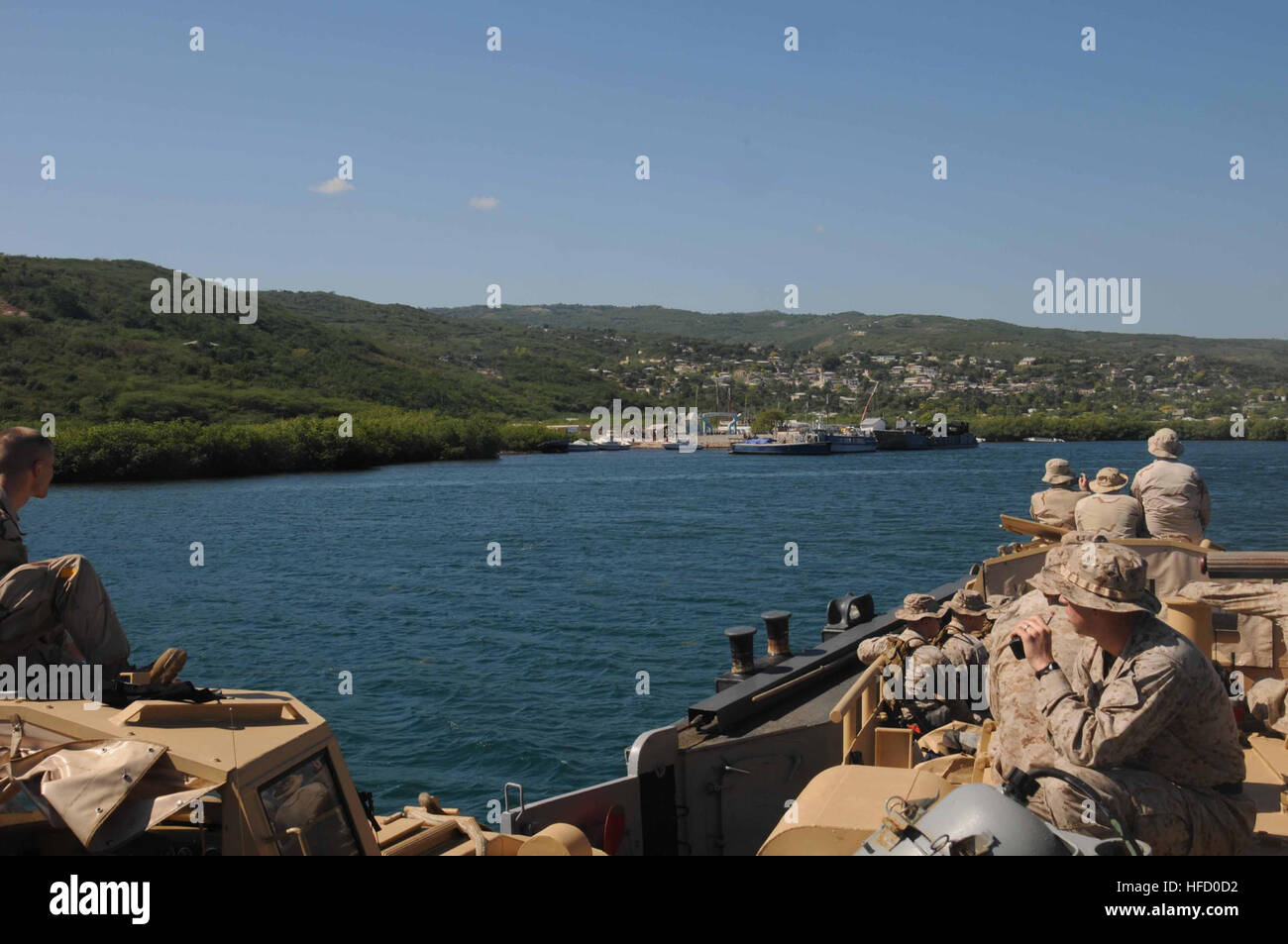 Sailors assigned to the amphibious assault ship USS Nassau approach ...