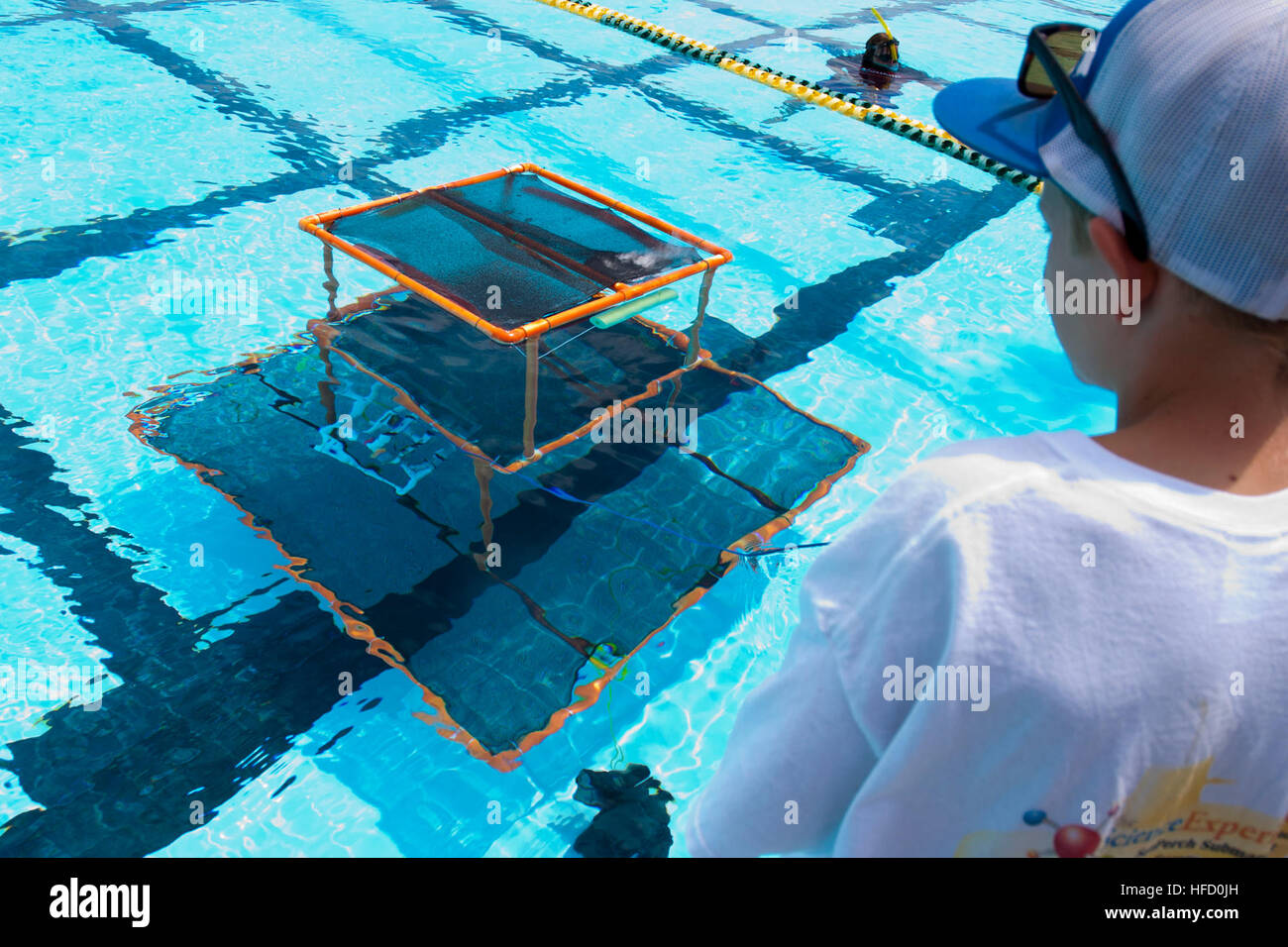 A member of the Men of Steel team helps guide their submersible around ...