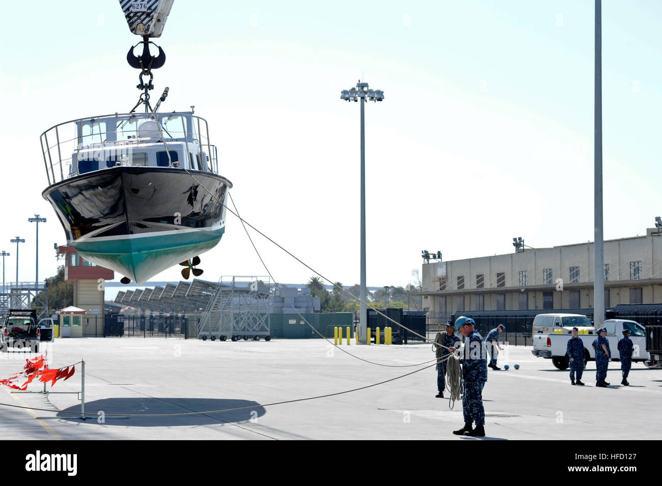 U.S. Navy Carrier Strike Group 11's admiral's barge hangs in the air as ...