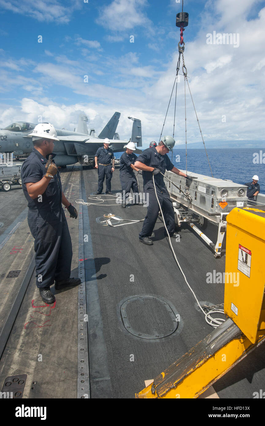 Sailors steady an Evolved Sea Sparrow Missile (ESSM) canister prior to ...