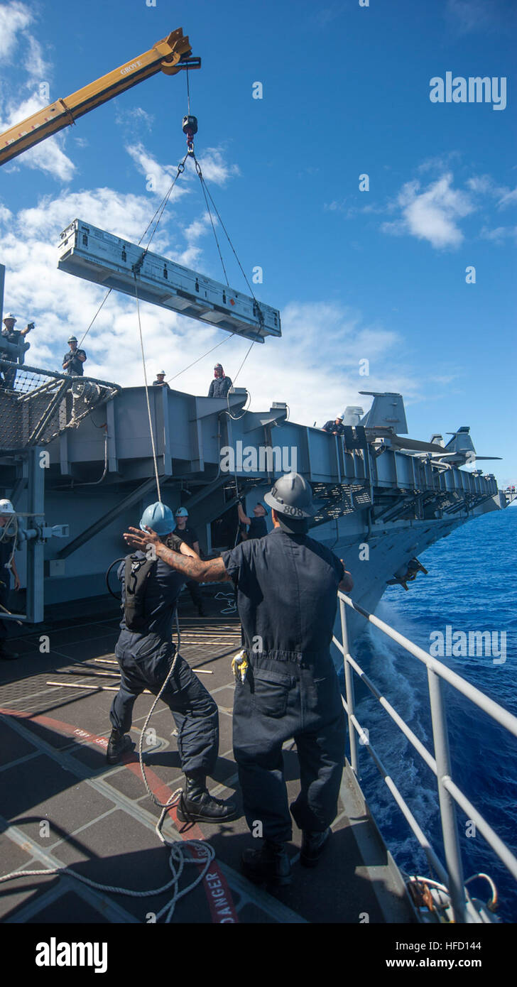 Fire controlmen raise an Evolved Sea Sparrow Missile (ESSM) canister to ...