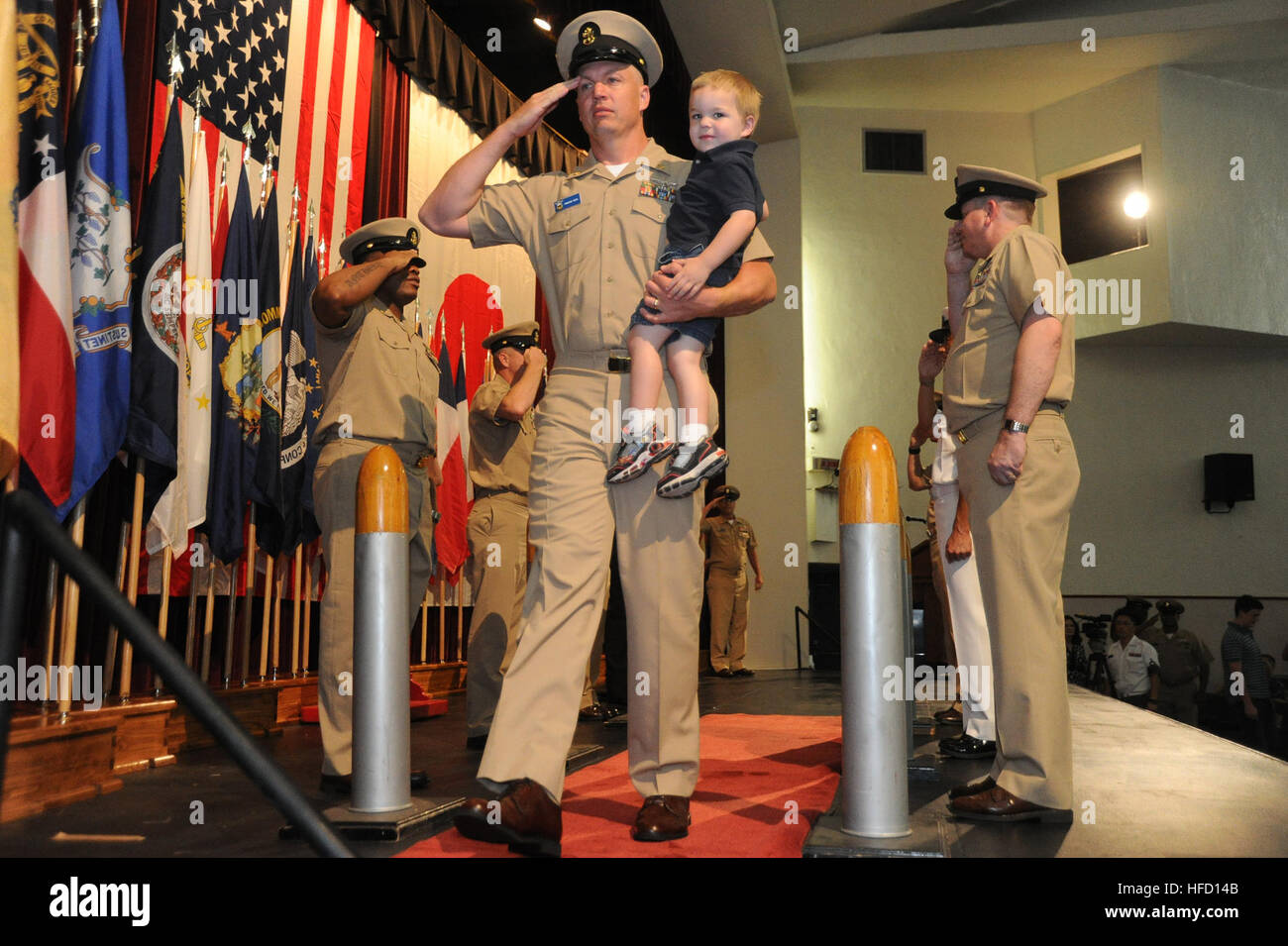 Chief Petty Officer Vincent Rock is piped through side boys with his ...