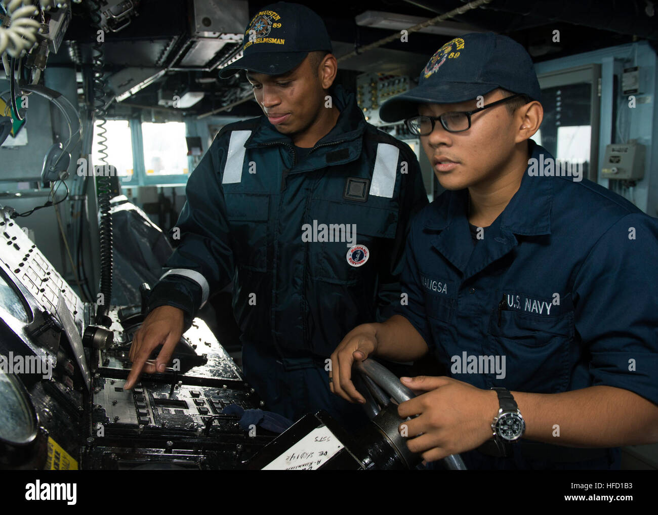 EAST CHINA SEA (Oct. 14, 2013) Seaman Melvin Rodas, right, instructs ...