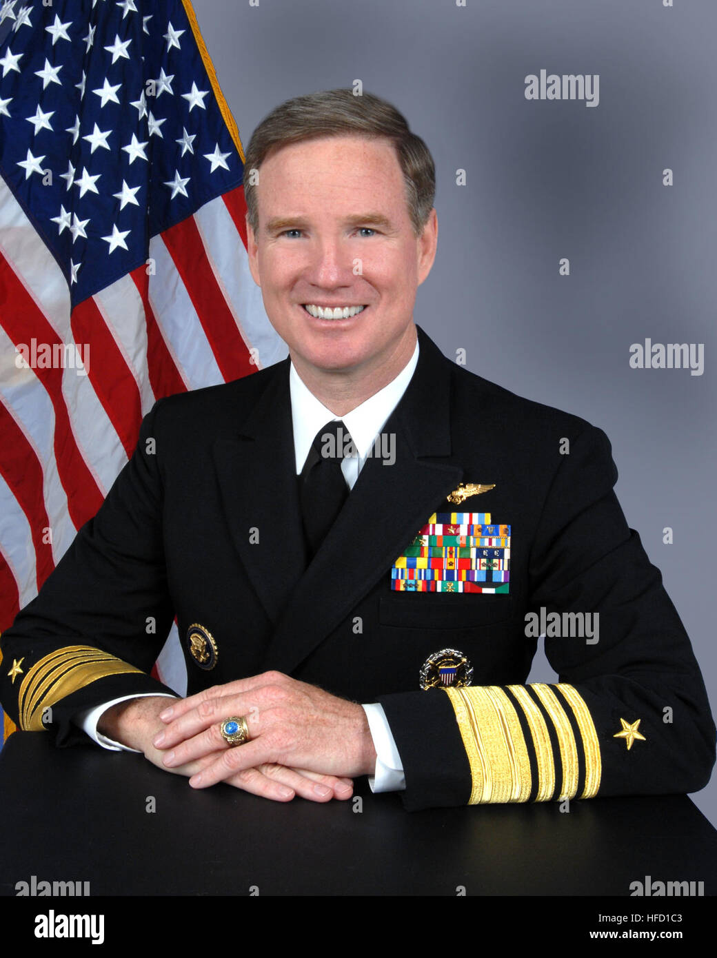 A formal portrait shows an admiral of the U.S. Navy in uniform ...
