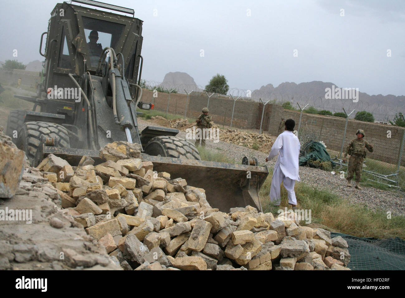 A Seabee from Naval Mobile Construction Battalion 26 clears debris from ...