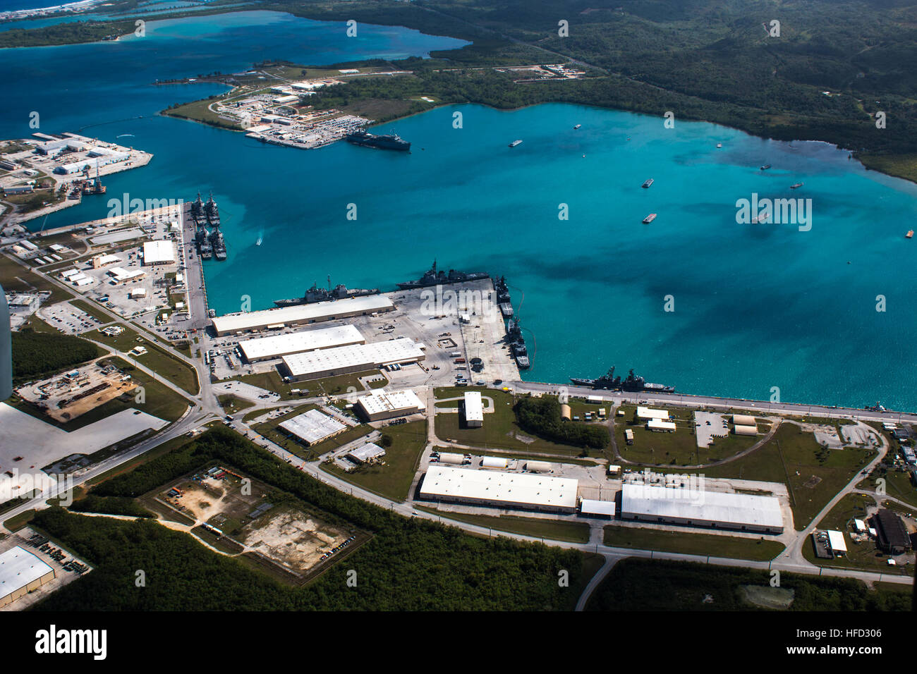 An aerial view of U.S. Naval Base Guam shows Apra Harbor with multiple ...
