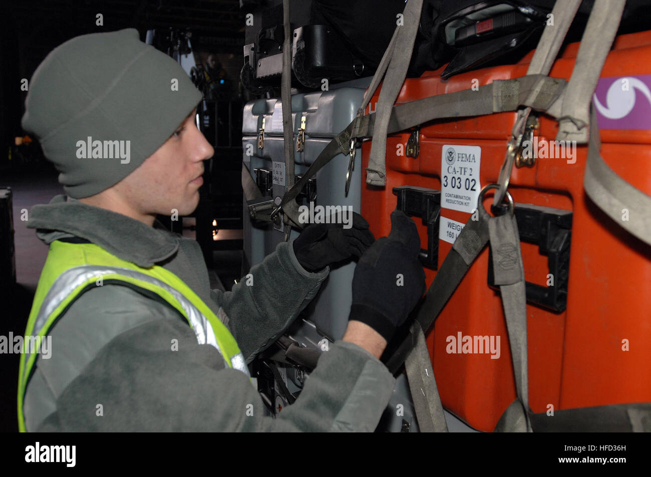 Airman 1st Class Nick Coniglio secures a pallet of gear belonging to ...