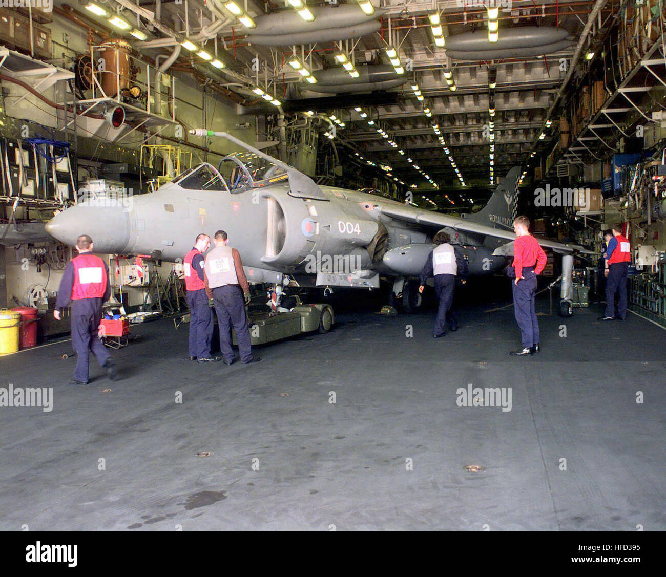 British crewmen prepare to move a Royal Navy FA-2 Sea Harrier onto the ...
