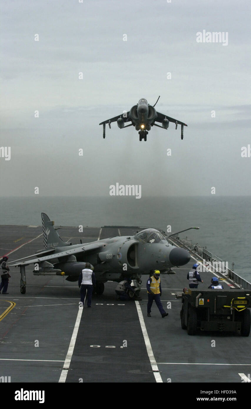 An AV-8B Sea Harrier jet hovers above the flight deck of HMS ...