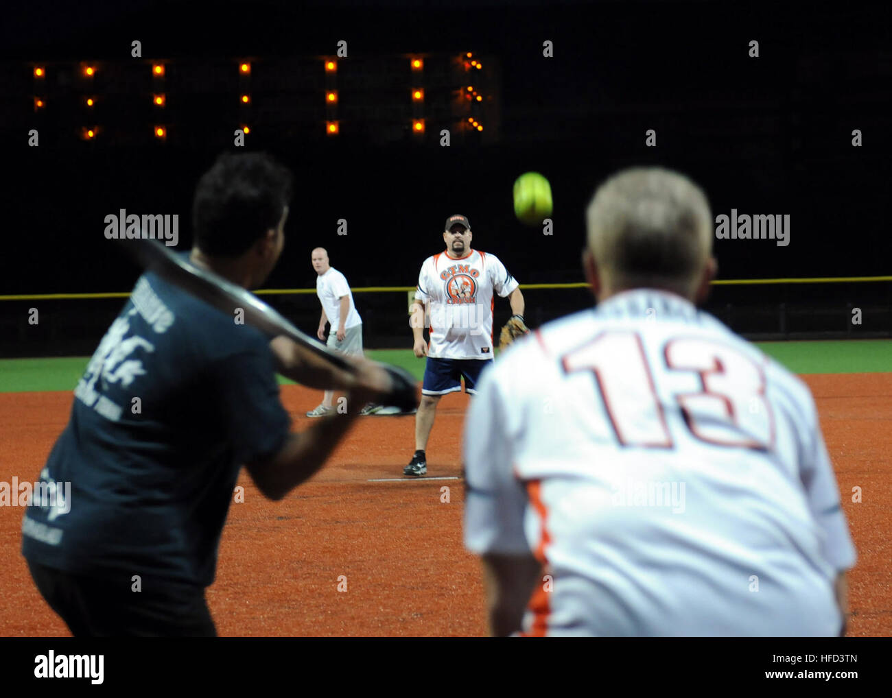 Mark Massa, a member of the GTMO Crush softball team, pitches a ...