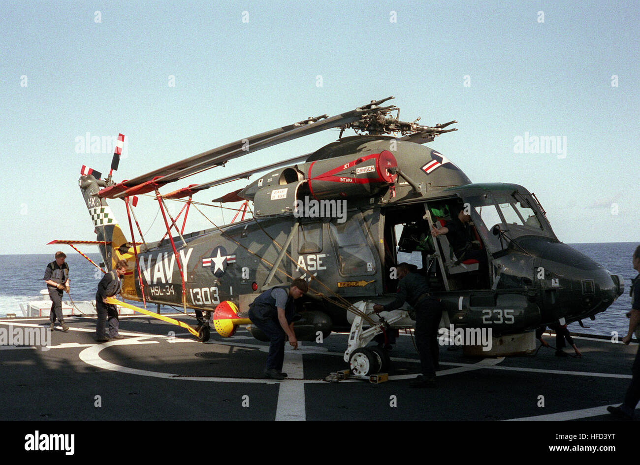 Crewmen aboard the destroyer USS JOHN HANCOCK (DD-981) prepare an SH-2F ...