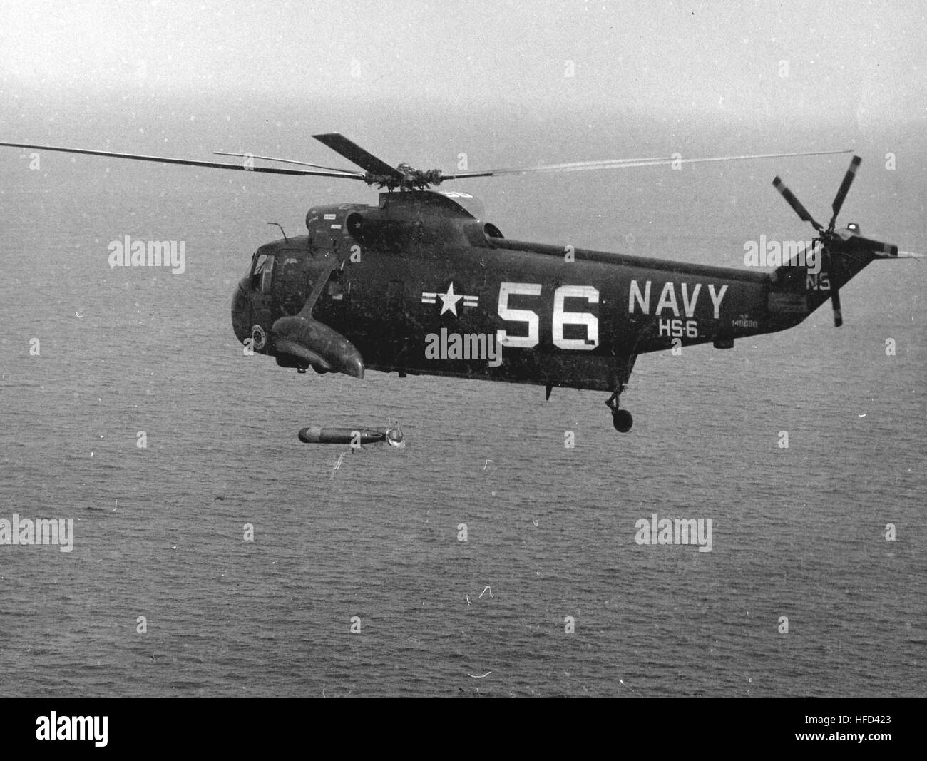 An SH-3A Sea King helicopter from HS-6 performs a torpedo drop during ...