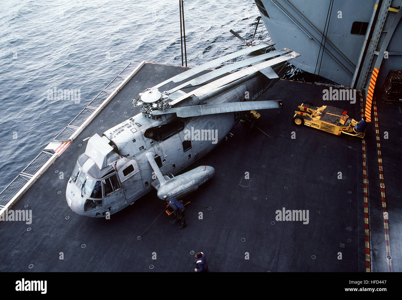 Crewmen chain down a Helicopter Anti-submarine Squadron 17 (HS-17) SH ...