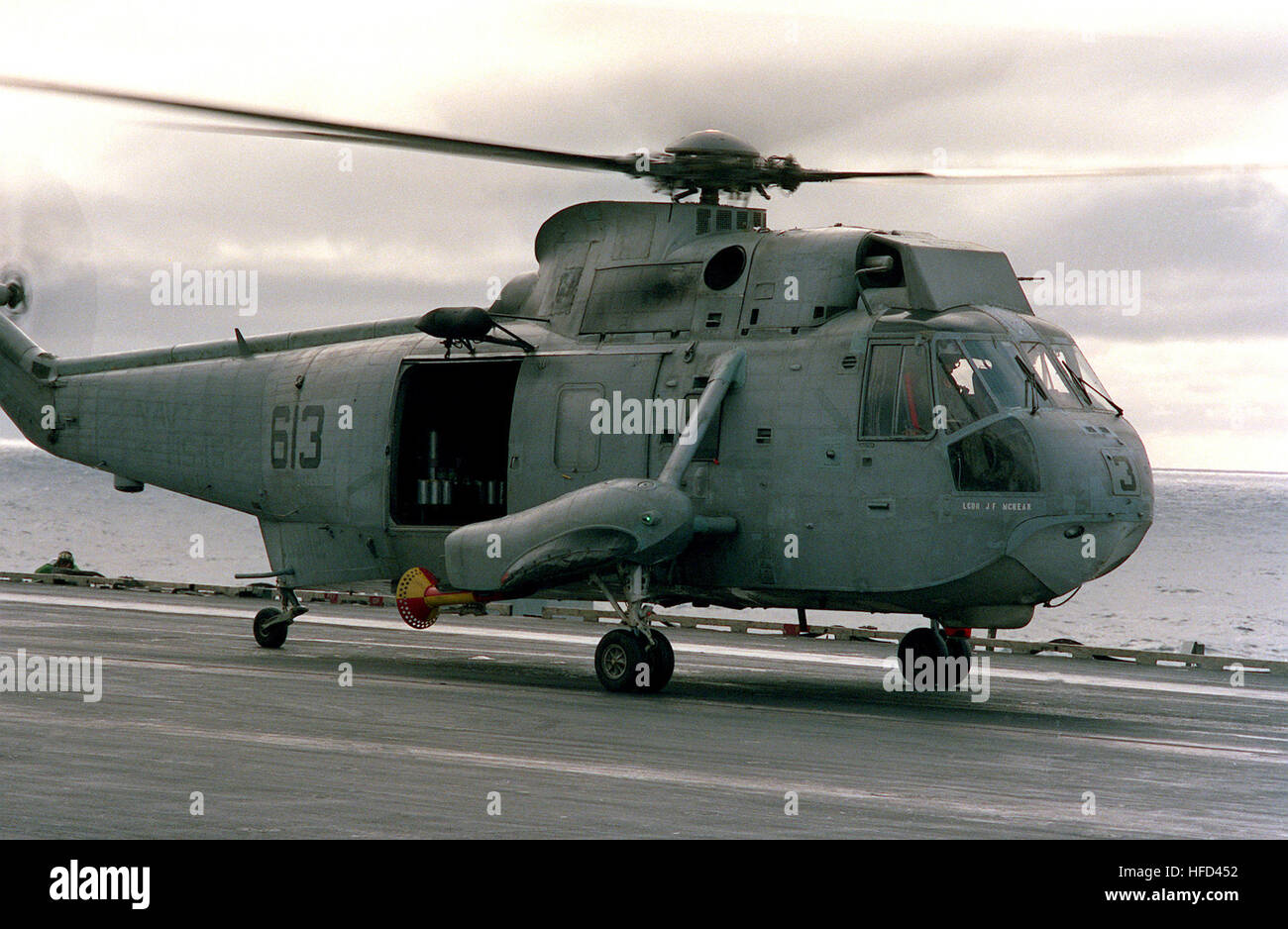 An SH-3 Sea King helicopter parked on the flight deck of the aircraft ...