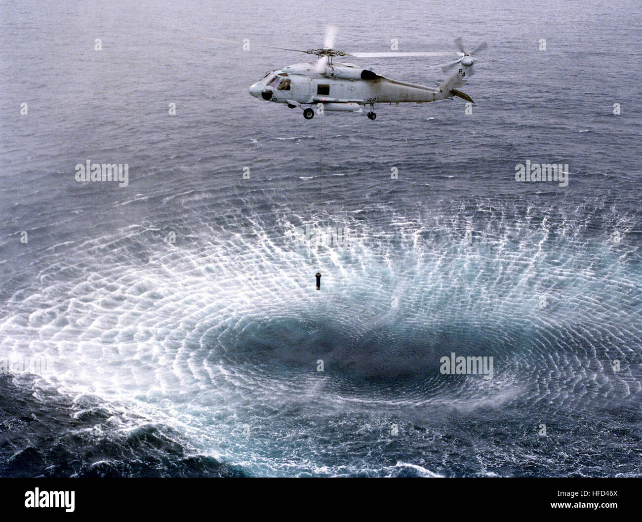 An SH-60F Seahawk helicopter from Antisubmarine Squadron HS-10 lowers a ...