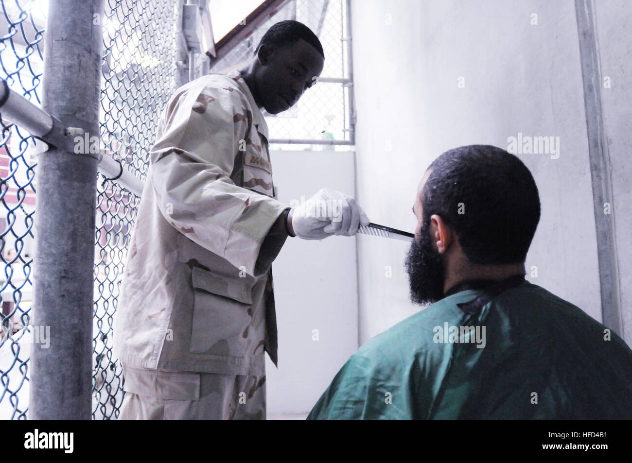 Petty Officer 3rd Class Darold Johnsonbrown, ship's serviceman, combs a ...