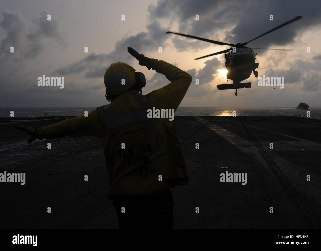 Petty Officer 2nd Class Jack Terry signals the pilot from the "Dragon ...