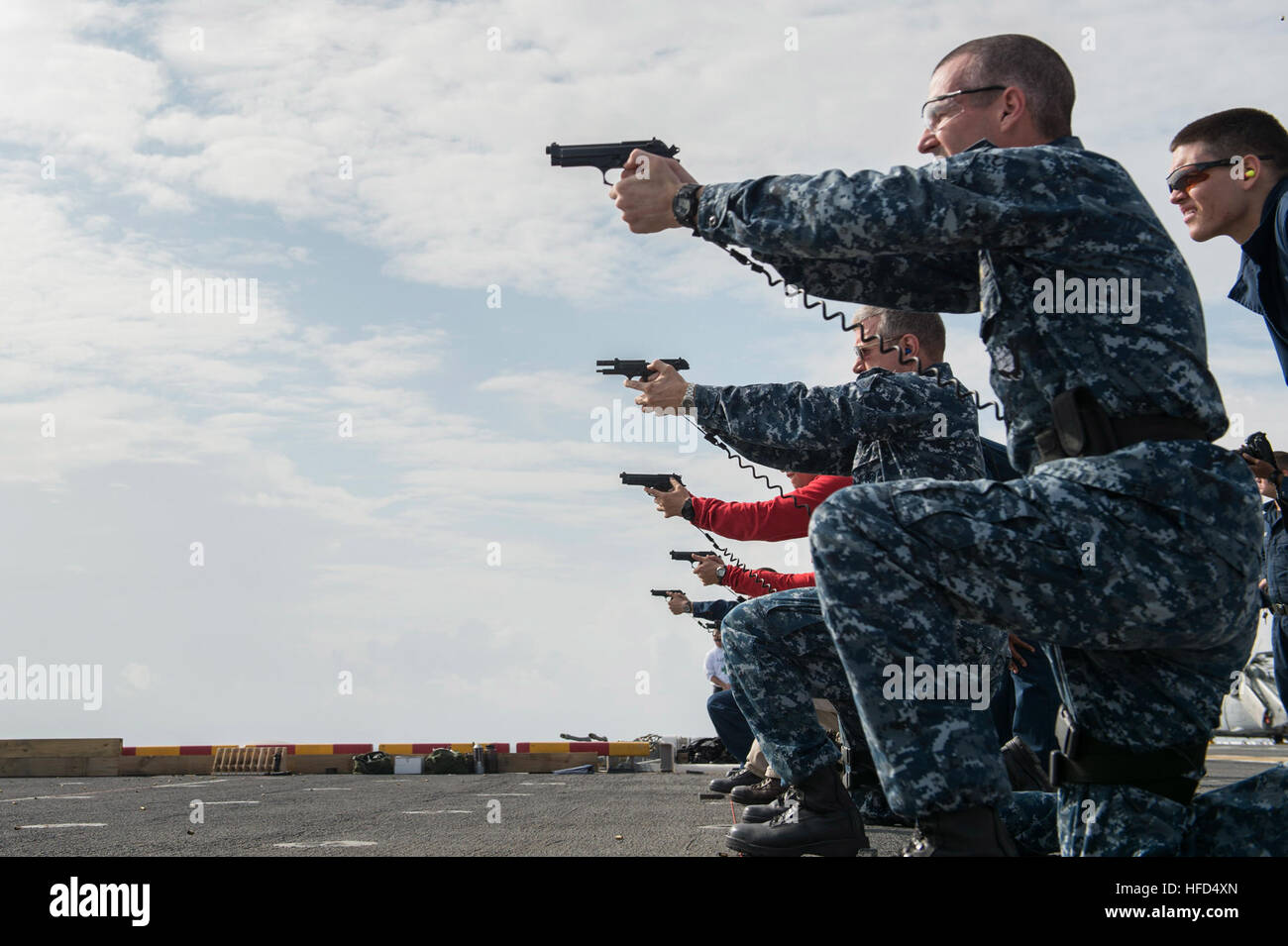 U.S. Navy Command Master Chief Chad Lunsford and Sailors with a weapons ...