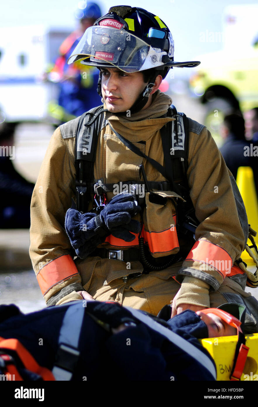 A Navy Region Mid-Atlantic fire and rescue responder watches over a ...