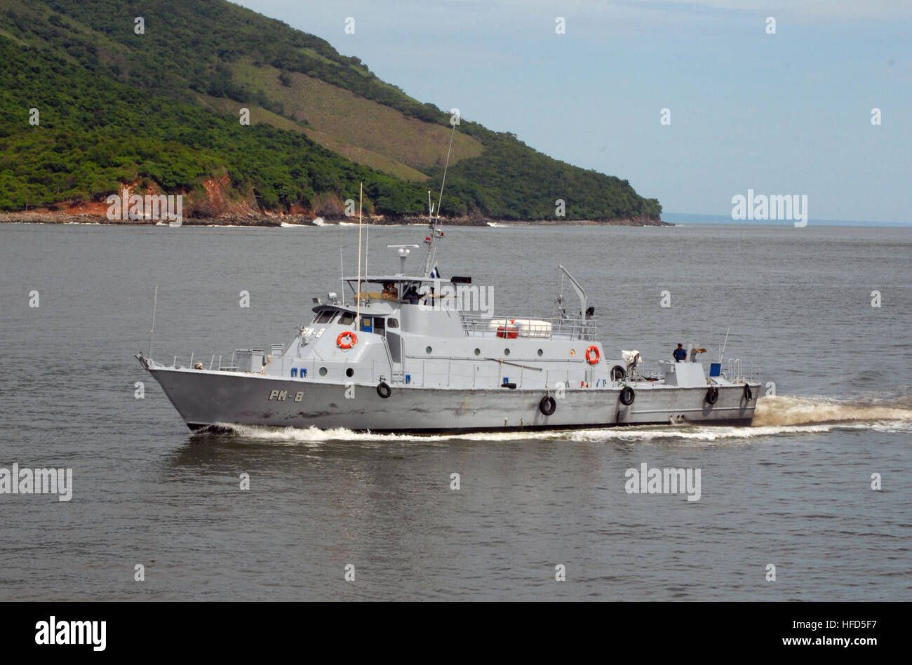 A patrol boat escorts High Speed Vessel Swift as it arrives for a port ...