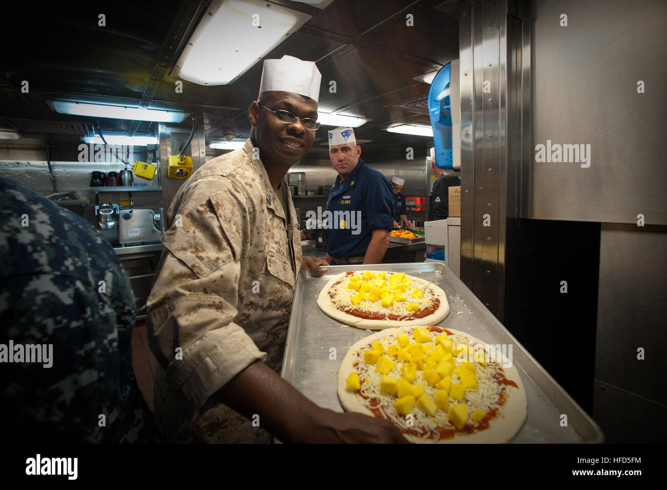 Master Gunnery Sgt. Erik Jackson shows off his gourmet masterpiece as ...