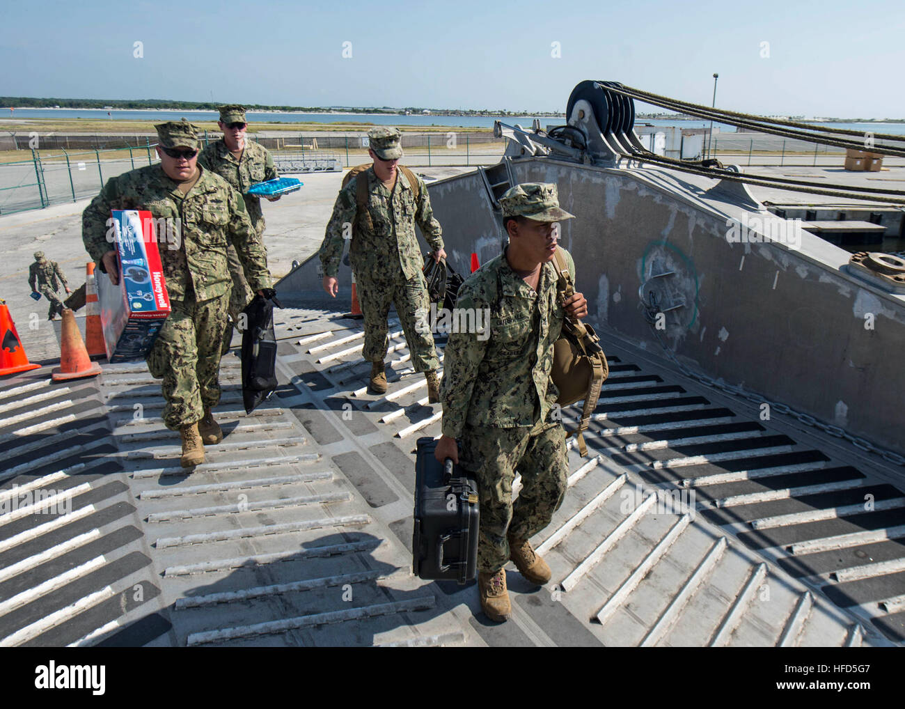 U.S. Sailors bring gear aboard the joint high speed vessel USNS ...