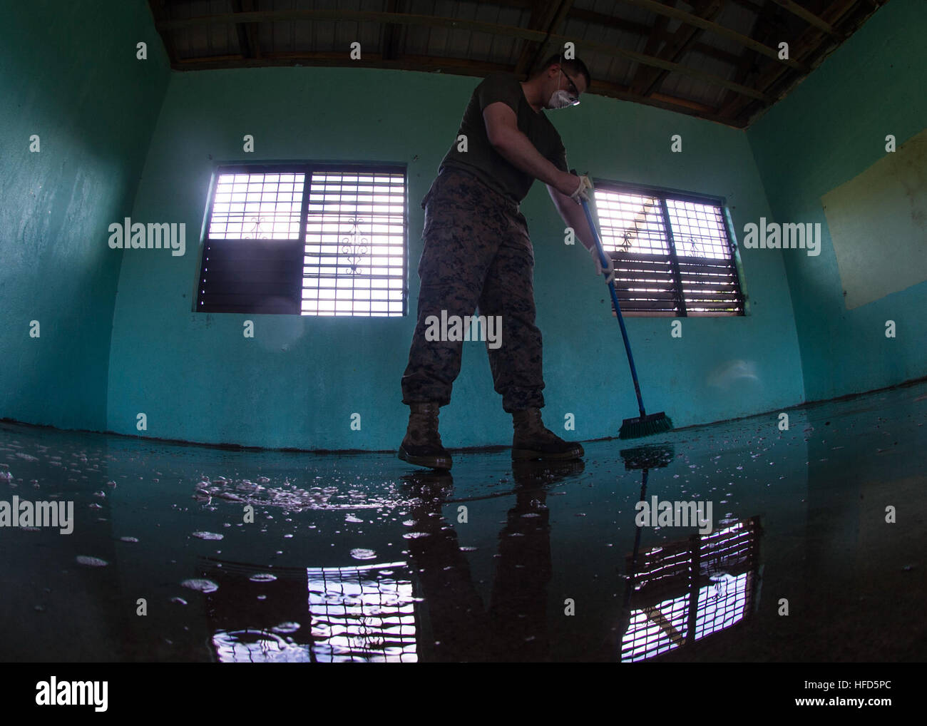 U.S. Marine Corps Lance Cpl. Grant Jacobson disinfects a classroom ...