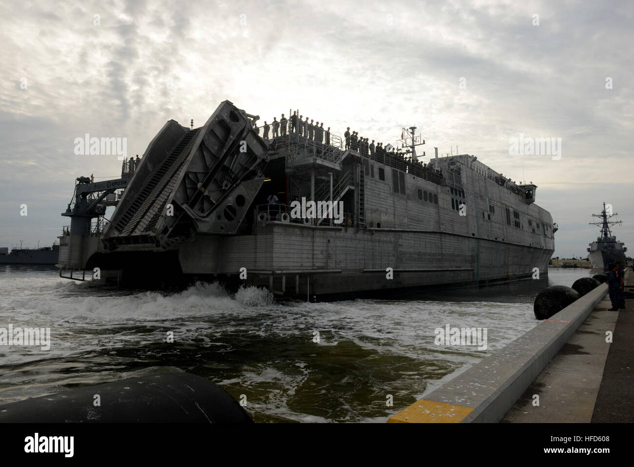 U.S. service members man the rails aboard the joint high speed vessel ...
