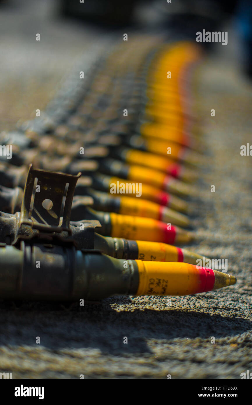 Rounds for a 25mm gun lay stretched on the ground aboard the guided ...