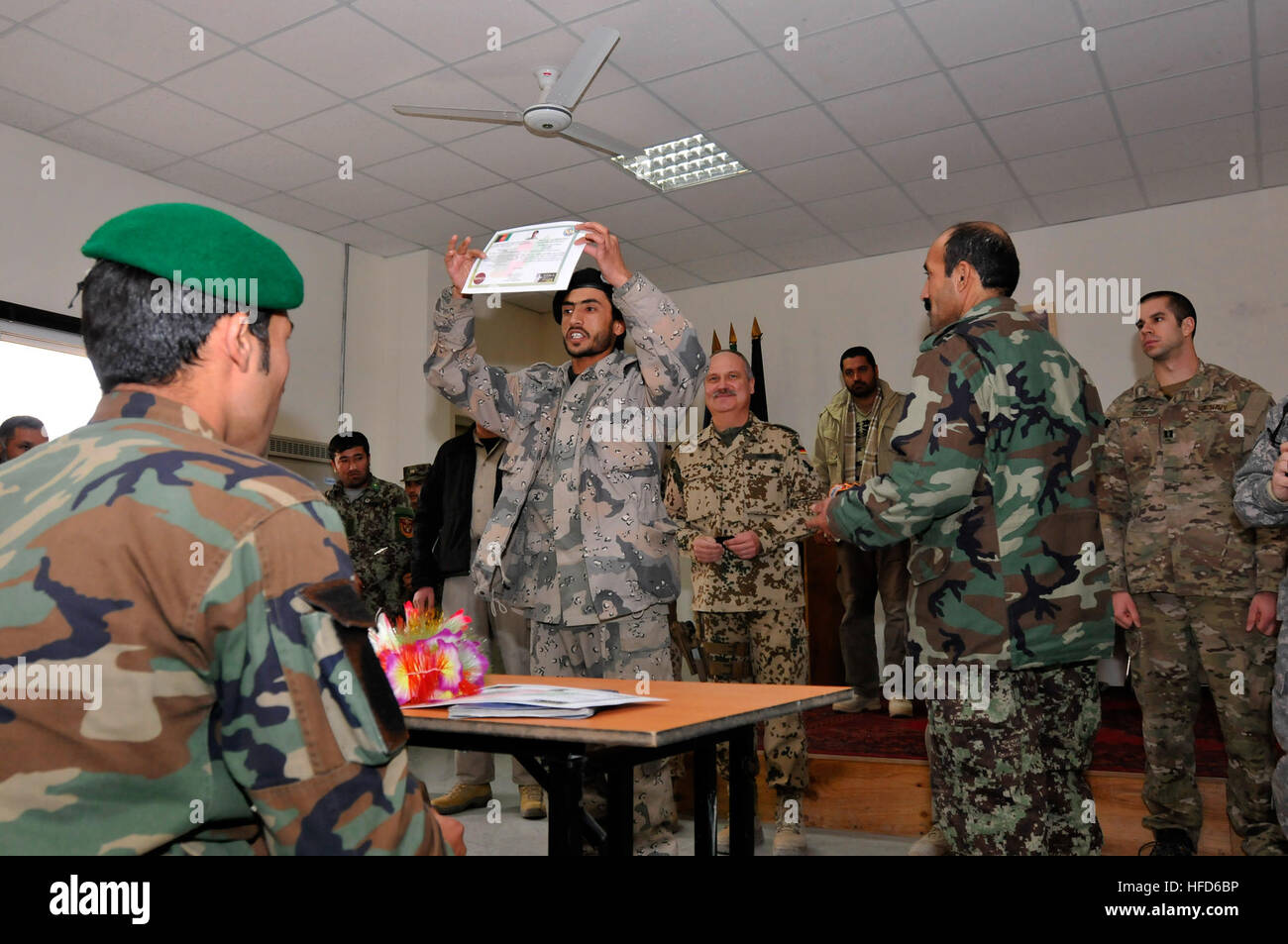An Afghan National Army soldier proudly displays his certificate during ...