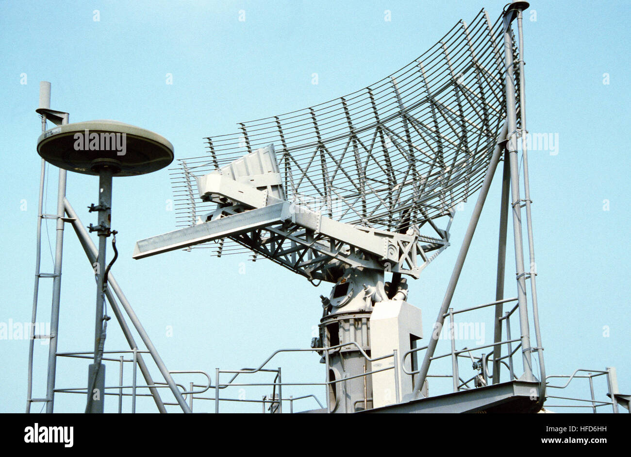 A view of the SPS-49 air search radar antenna mounted atop the lattice ...
