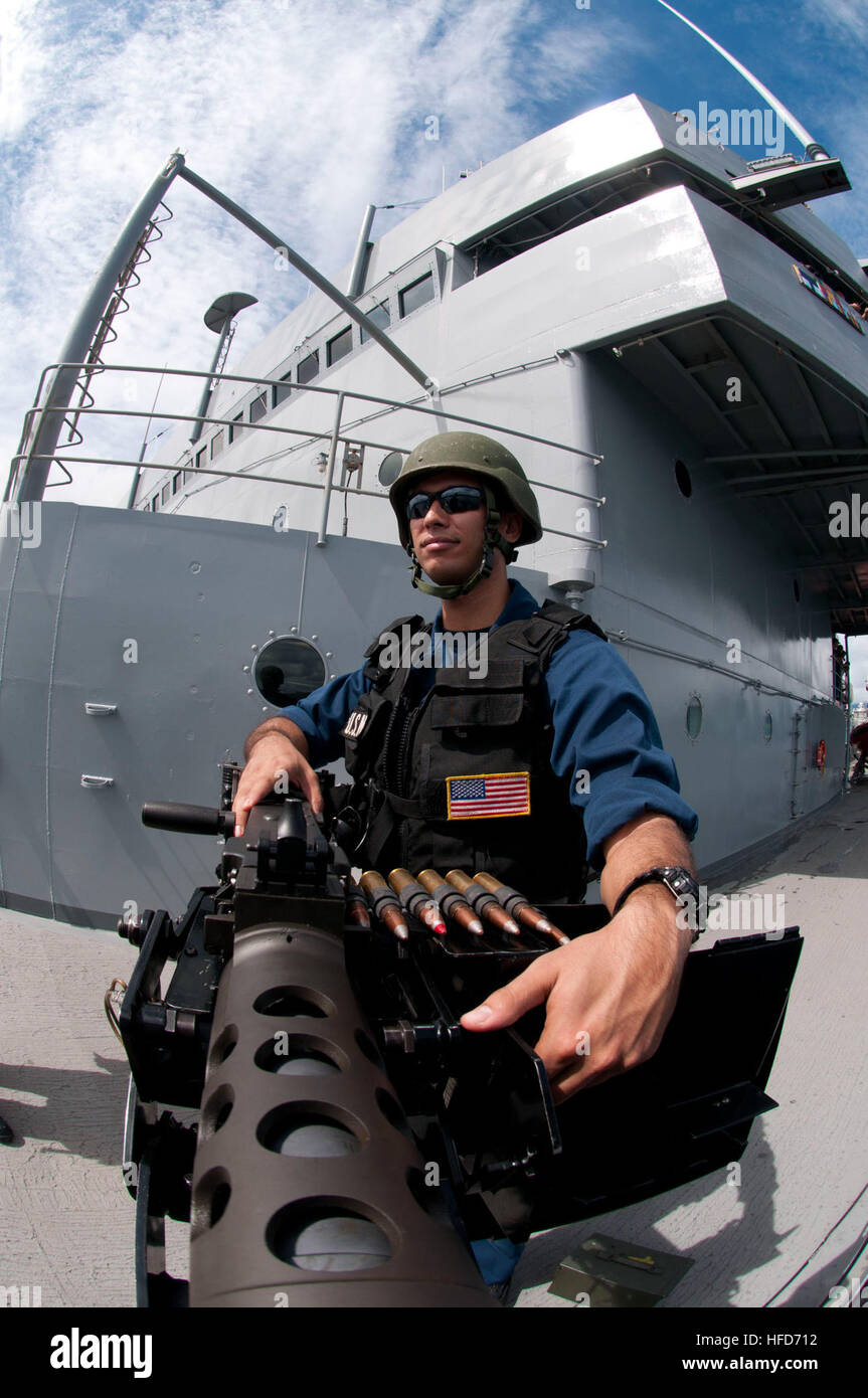 Fire Control Technician 1st Class Adam Gremp stands guard on a .50 ...