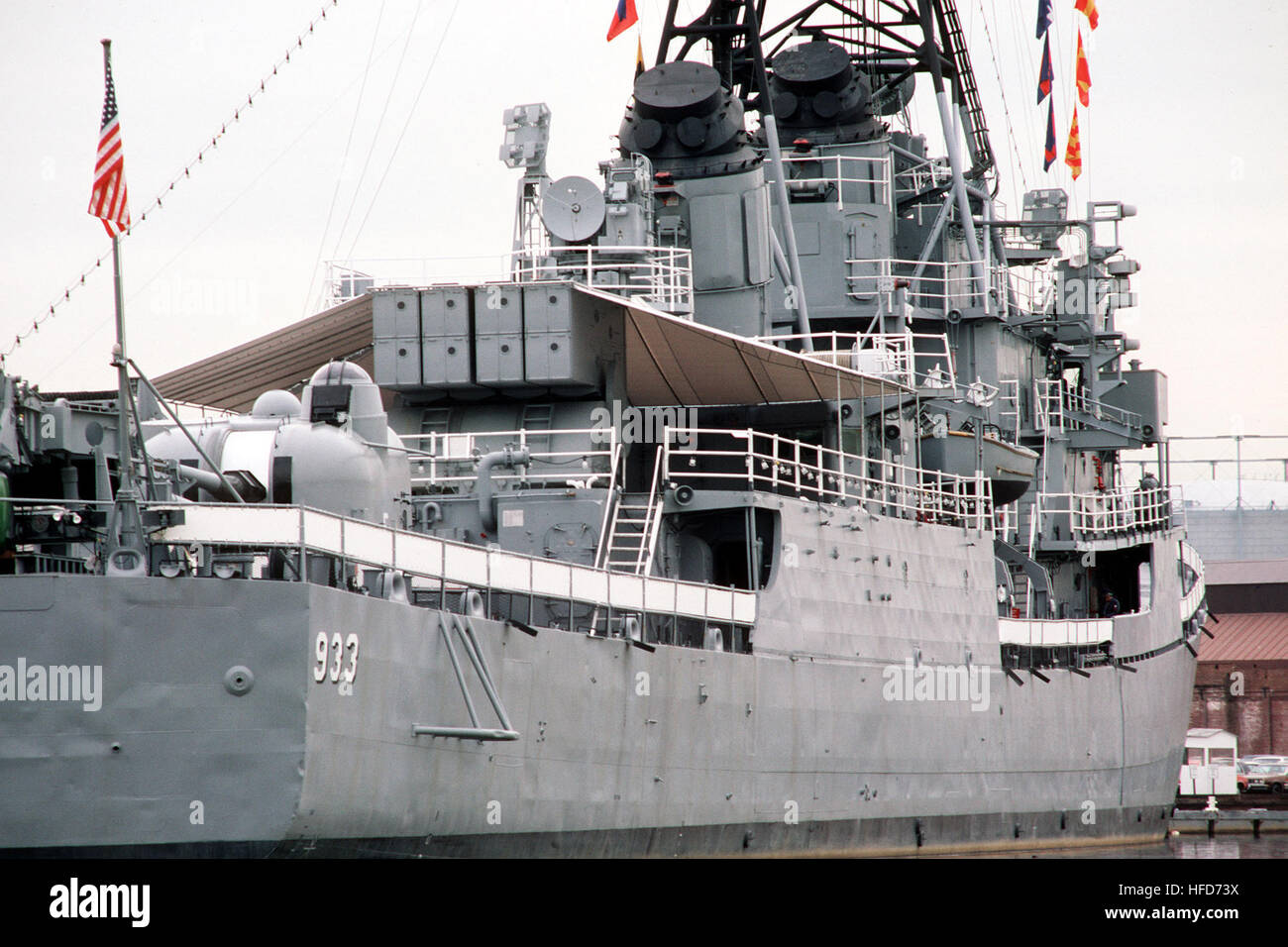 A starboard quarter view of the destroyer BARRY (DD 933) moored to a ...