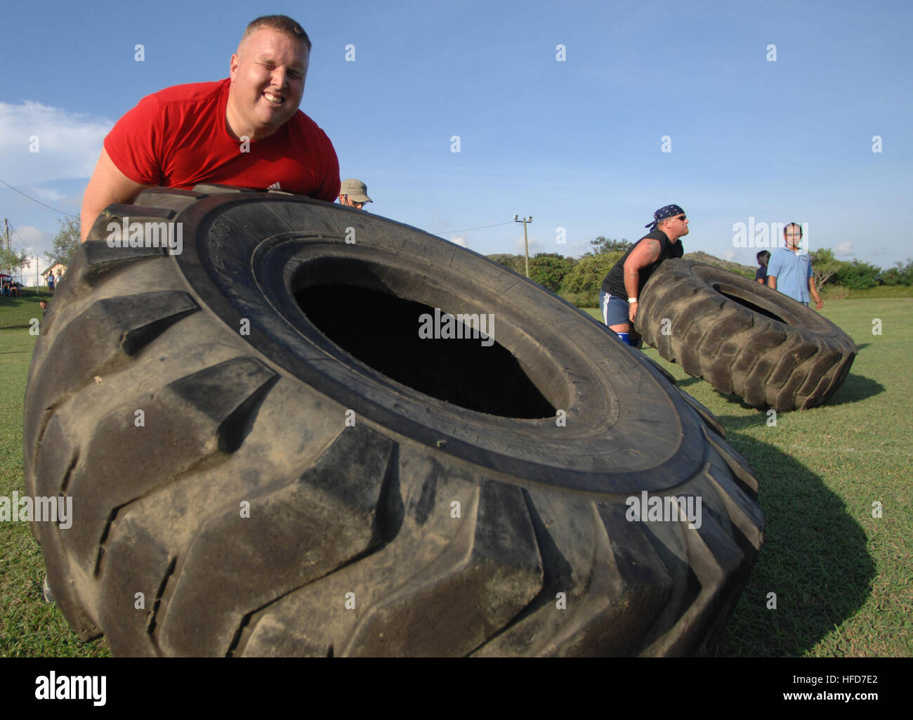 Dave Wright uses his brute strength to carry two 115 pound dumbbells to ...