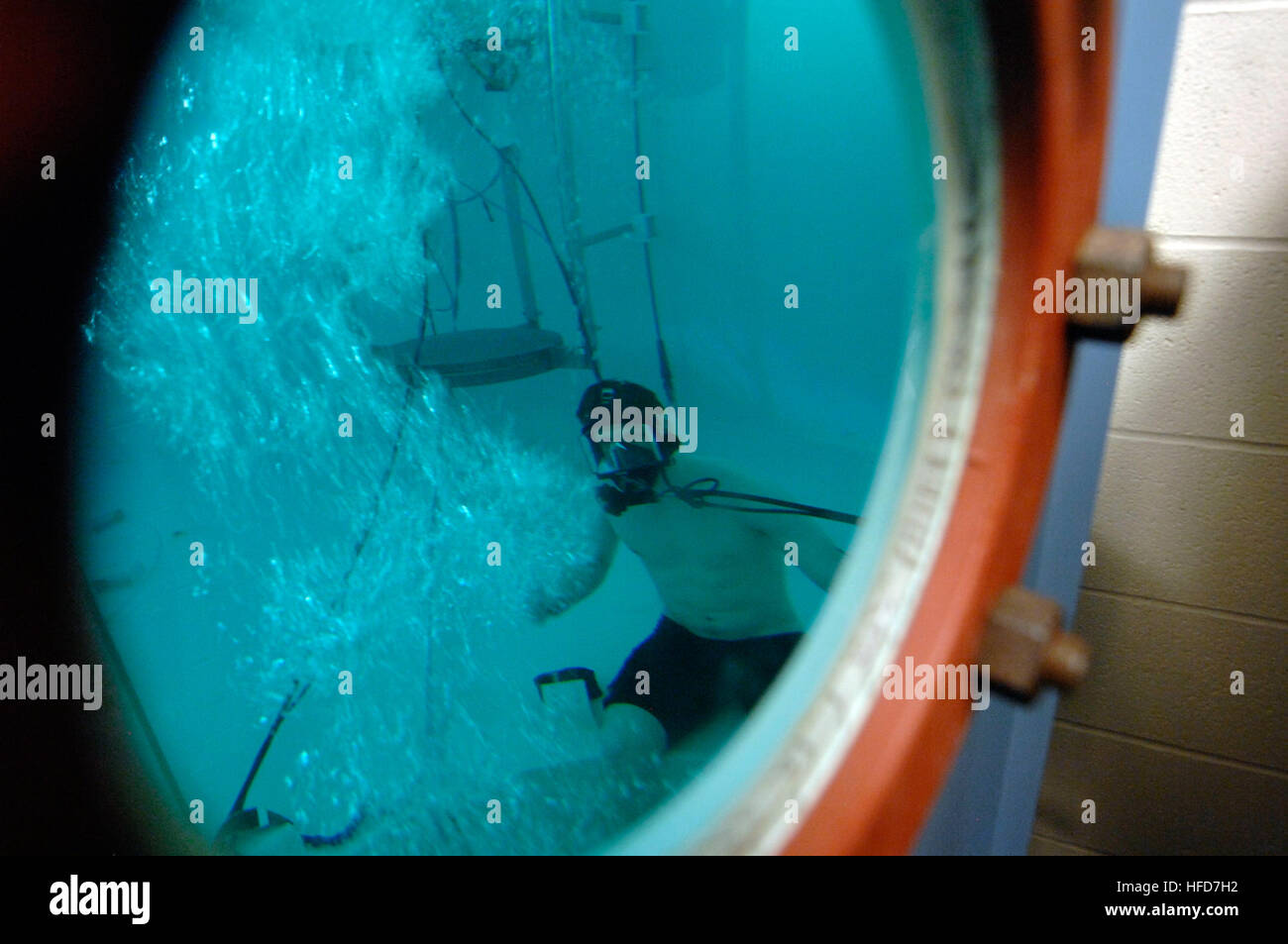 A Sailor trains in the submarine escape trainer at the Navy Submarine ...