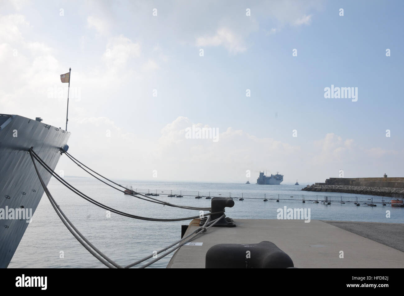 The container ship MV Cape Ray (T-AKR 9679), background, departs from ...