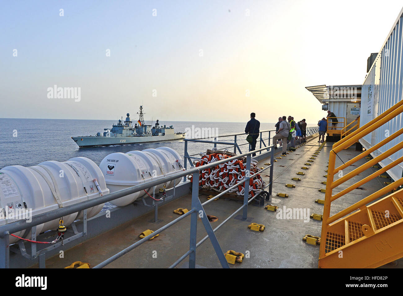 An escort ship, left, pulls alongside the container ship MV Cape Ray (T ...