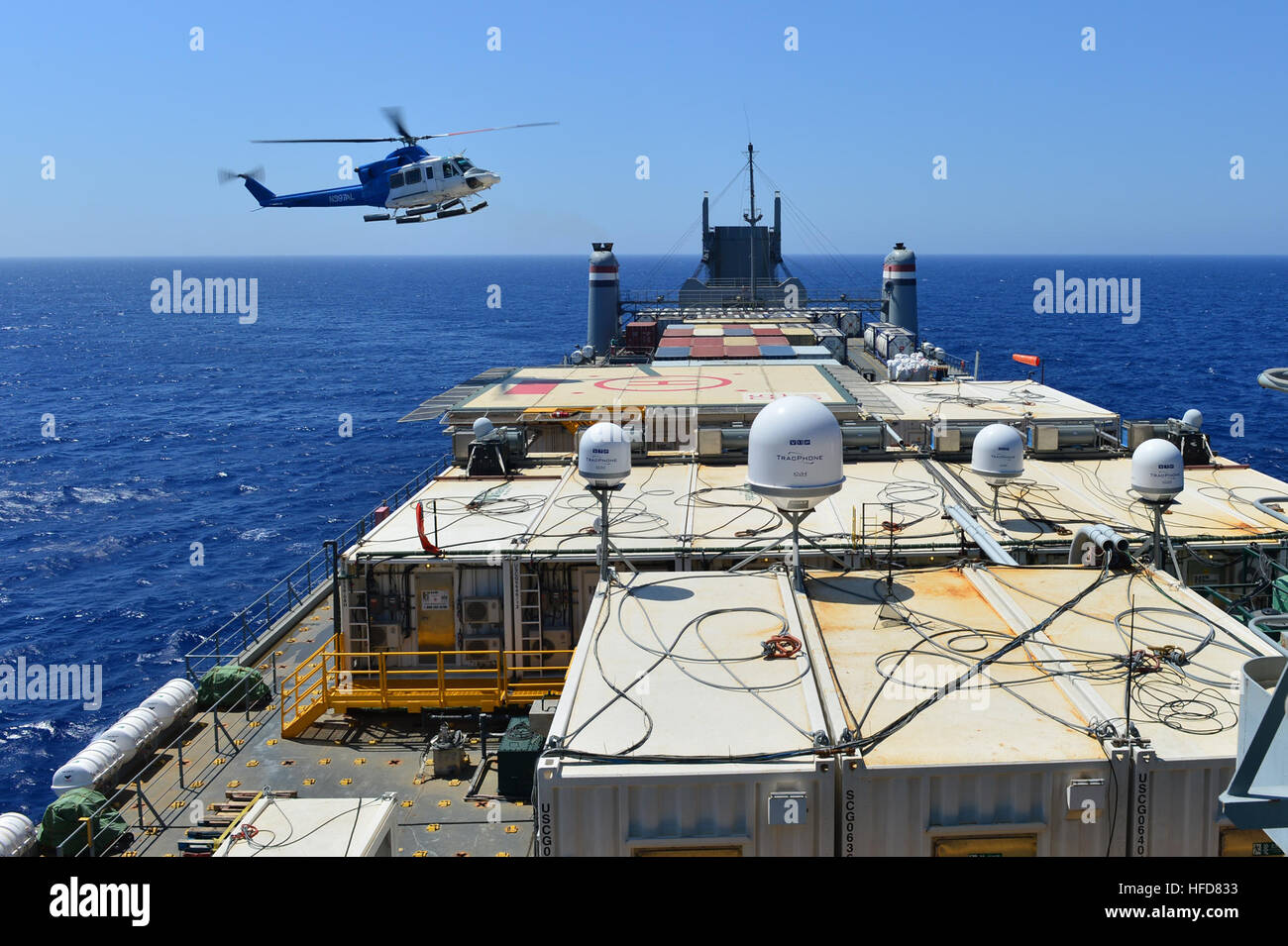 A helicopter approaches the container ship MV Cape Ray (T-AKR 9679) in ...