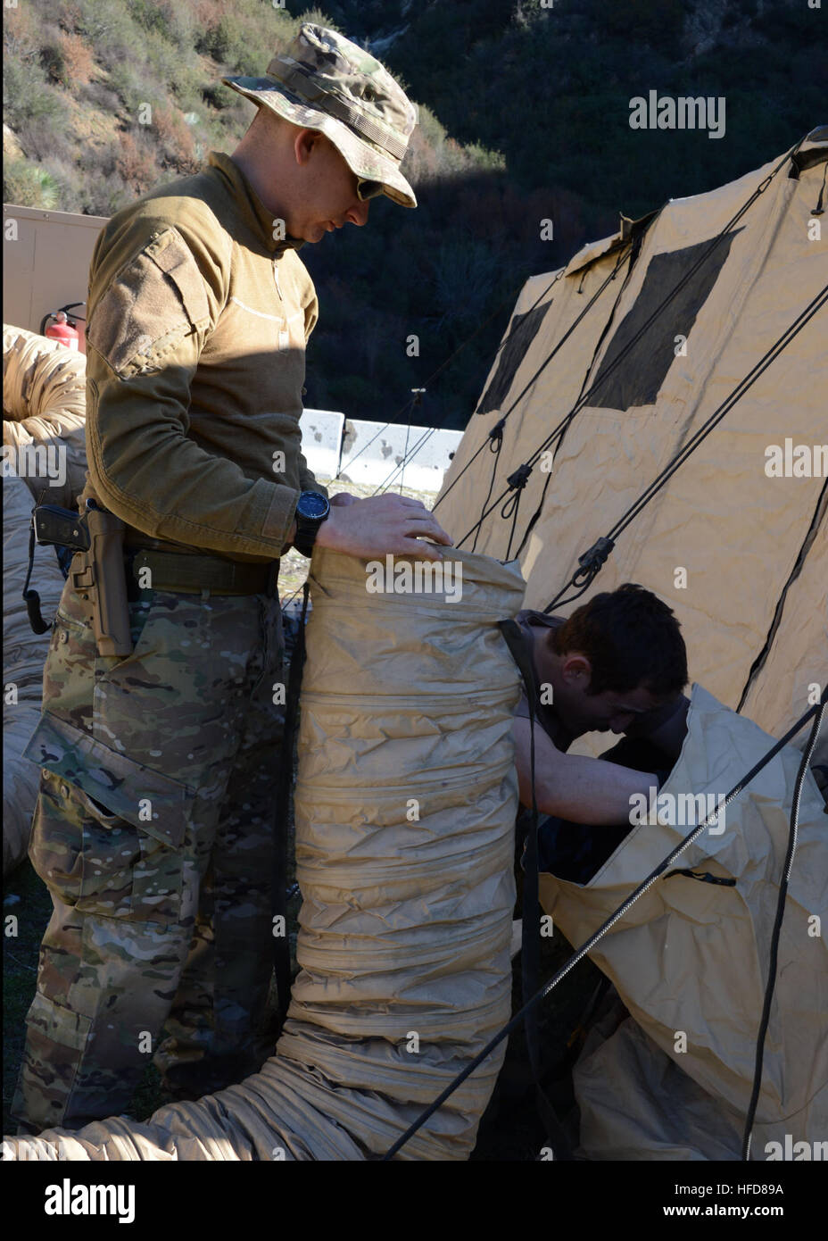 Fleet Combat Camera personnel set up heating equipment at a production ...