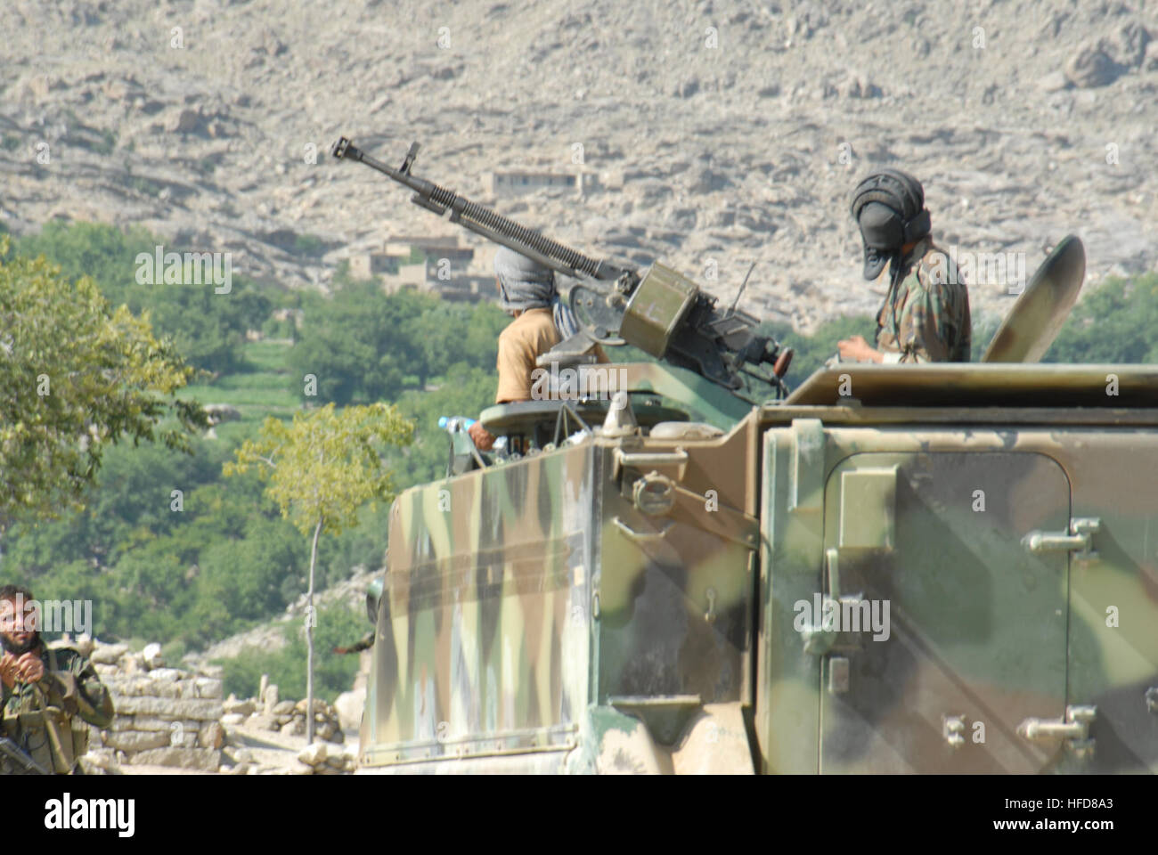 An Afghan national army soldier mans a machine gun on top of an M113 ...
