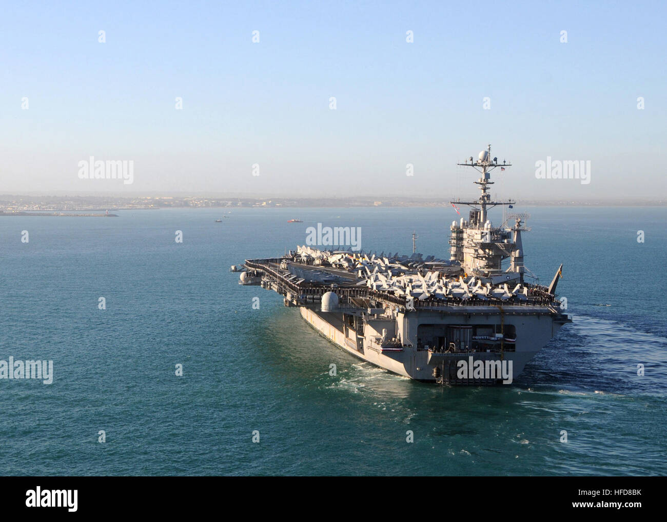 U.S. sailors man the rails aboard the aircraft carrier USS George ...