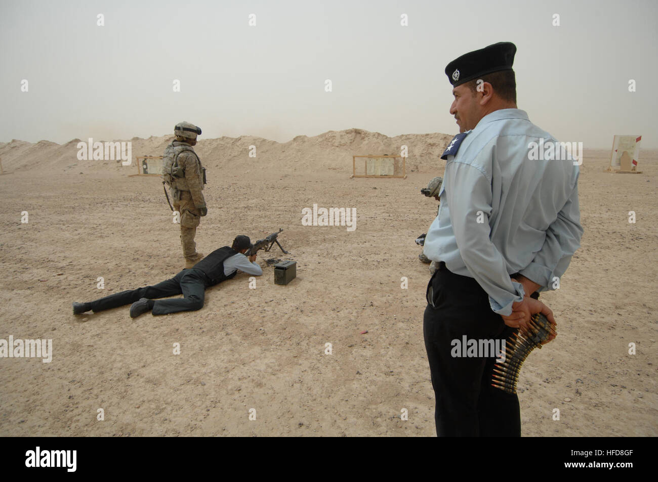 An Iraqi police officer waits for his turn during a training evaluation ...
