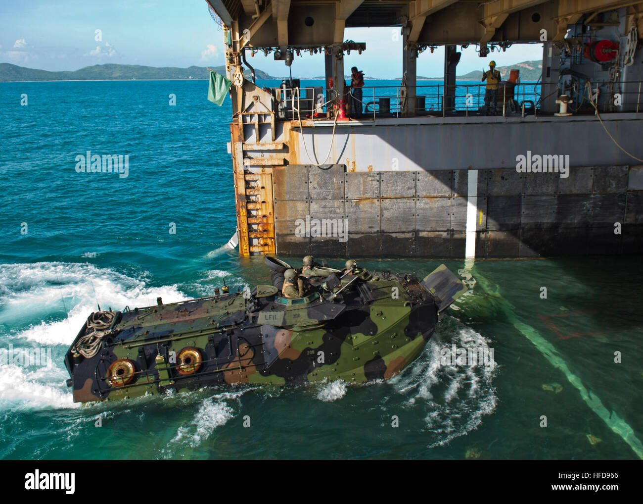 An amphibious assault vehicle (AAV) enters the well deck of the forward ...