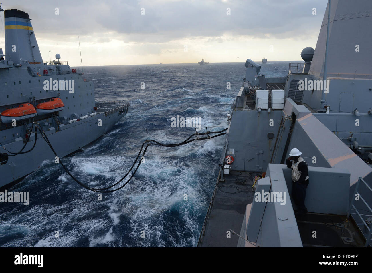 The amphibious transport dock ship USS Mesa Verde (LPD 19), right ...
