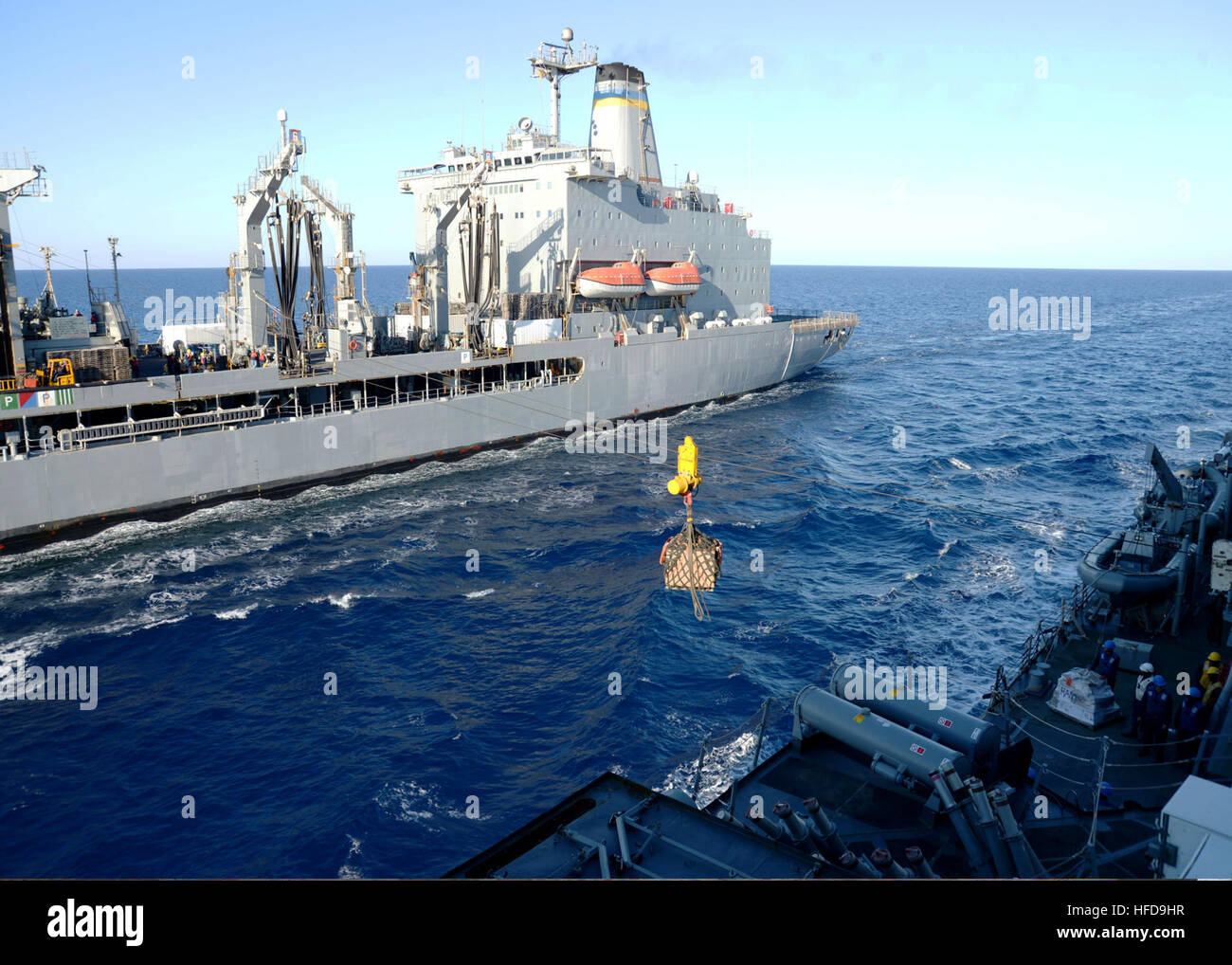 The guided missile destroyer USS Ramage (DDG 61), right, receives cargo ...